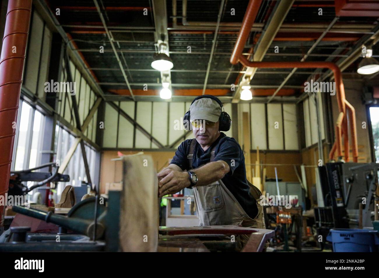 Carpenter Luis Ferreira demonstrates how he cuts custom wood pieces ...