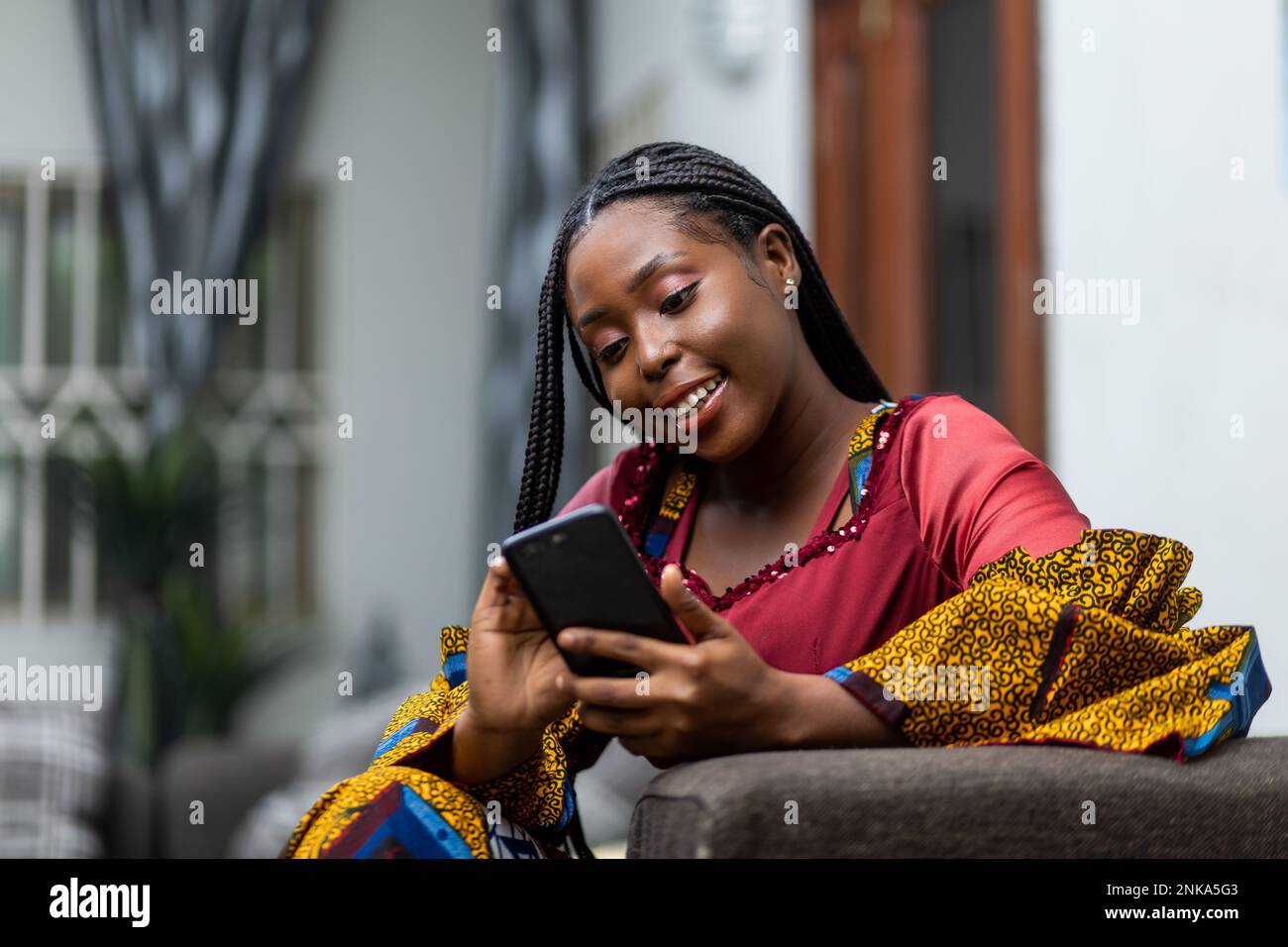 African Woman doing Mobile banking and financial transactions on her ...