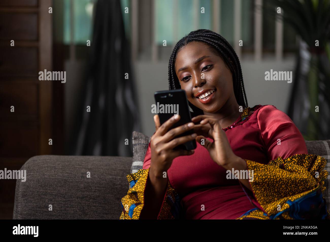 African woman smartphone home hi-res stock photography and images - Alamy