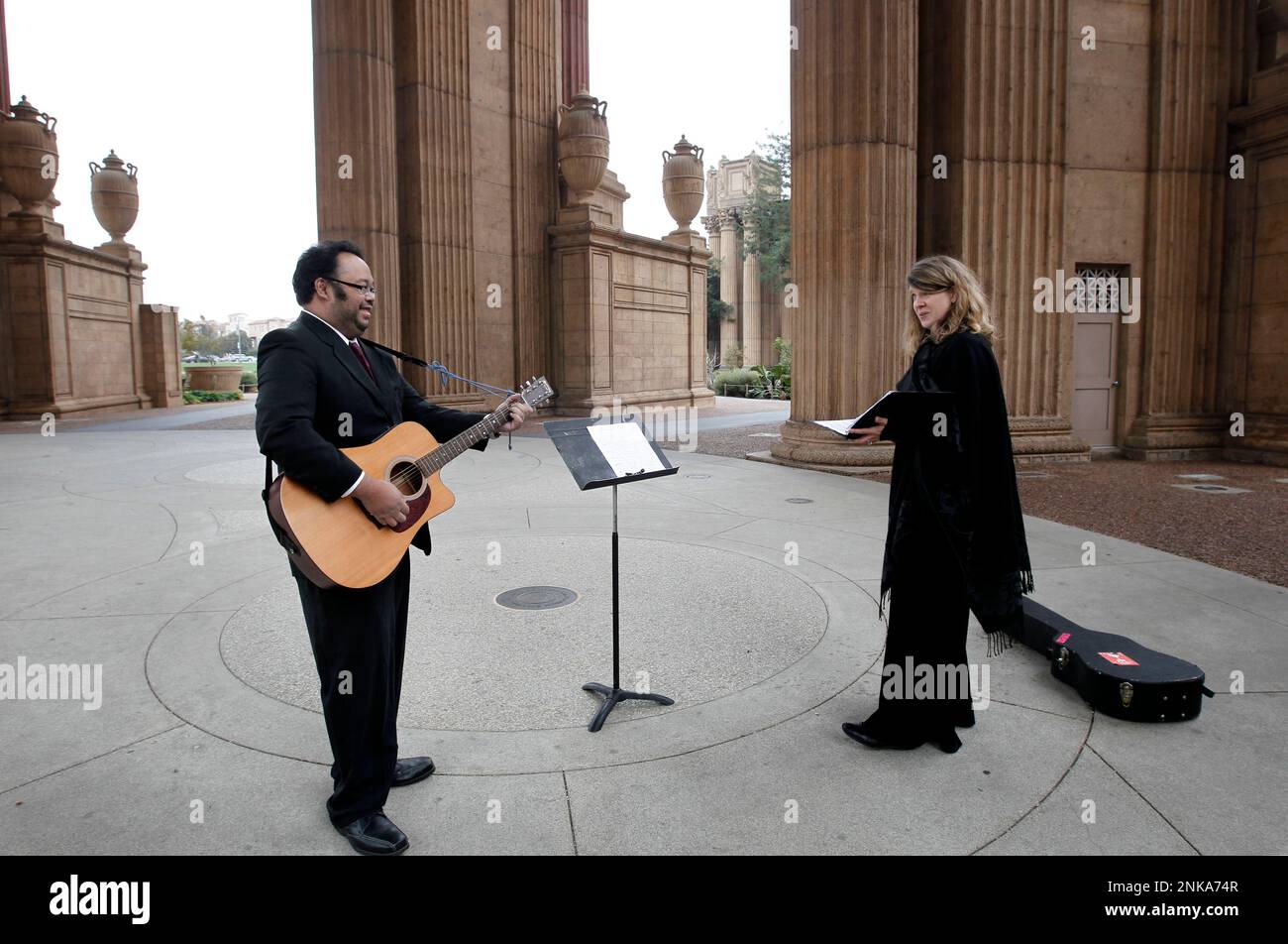 Oliver Cruz and Lisa May warm up for a wedding they are playing shortly ...