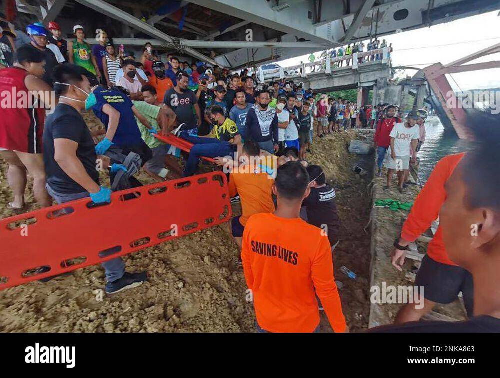 In this photo provided by the Philippine Coast Guard, rescuers carry a ...