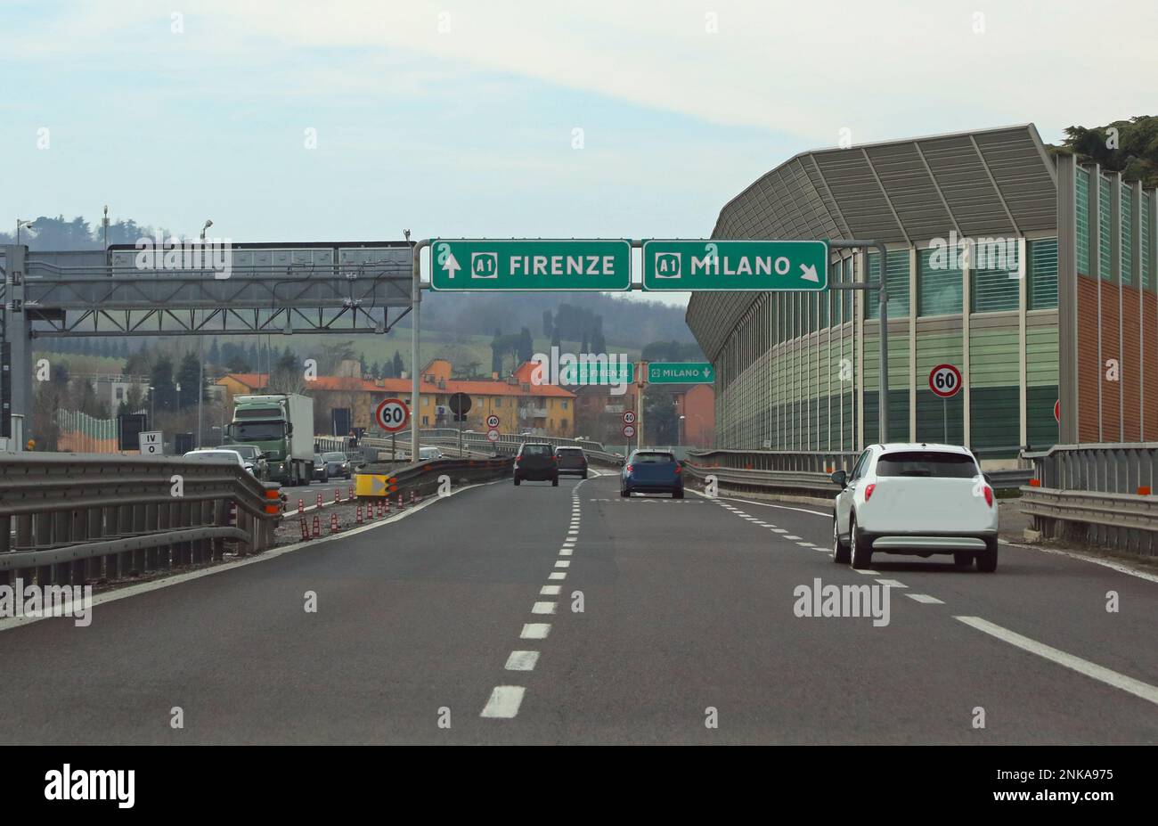 Wide italian Road Signal at crossroad with name of City MILAN and ...