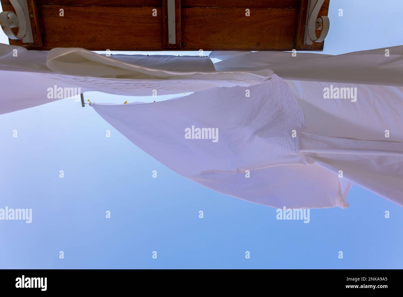White linen drying on clothesline in fishing village of Symi, Island in ...