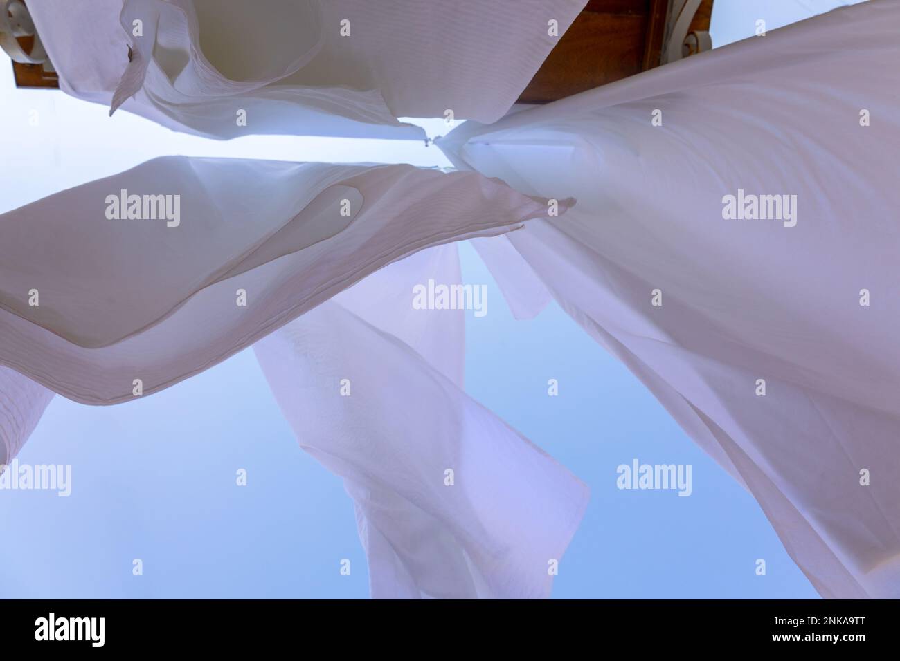 White linen drying on clothesline in fishing village of Symi, Island in ...