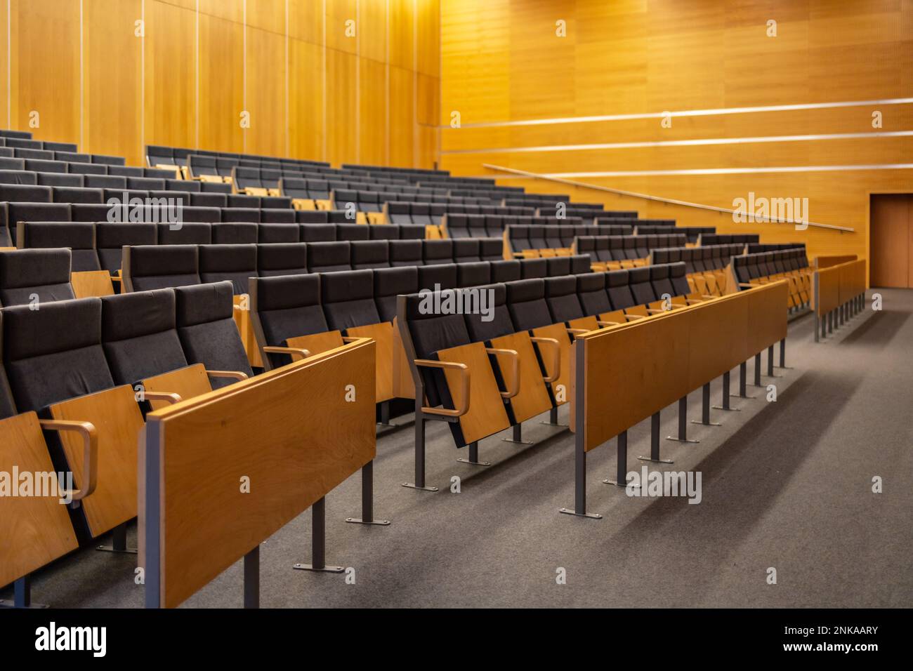 Interior of big conference hall full of gray folding chairs and wooden ...