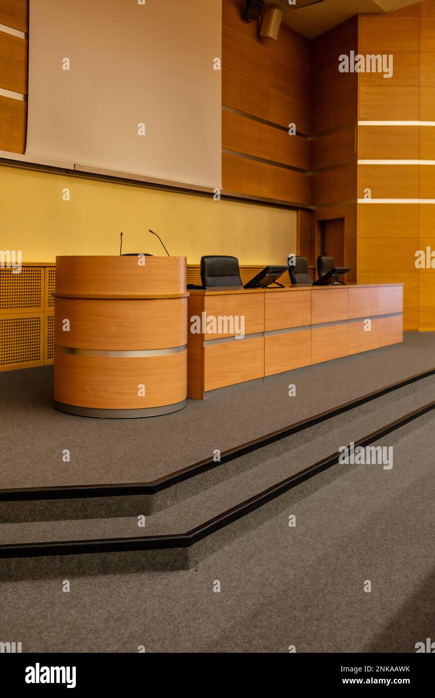 Interior of big conference hall full of gray folding chairs and wooden ...