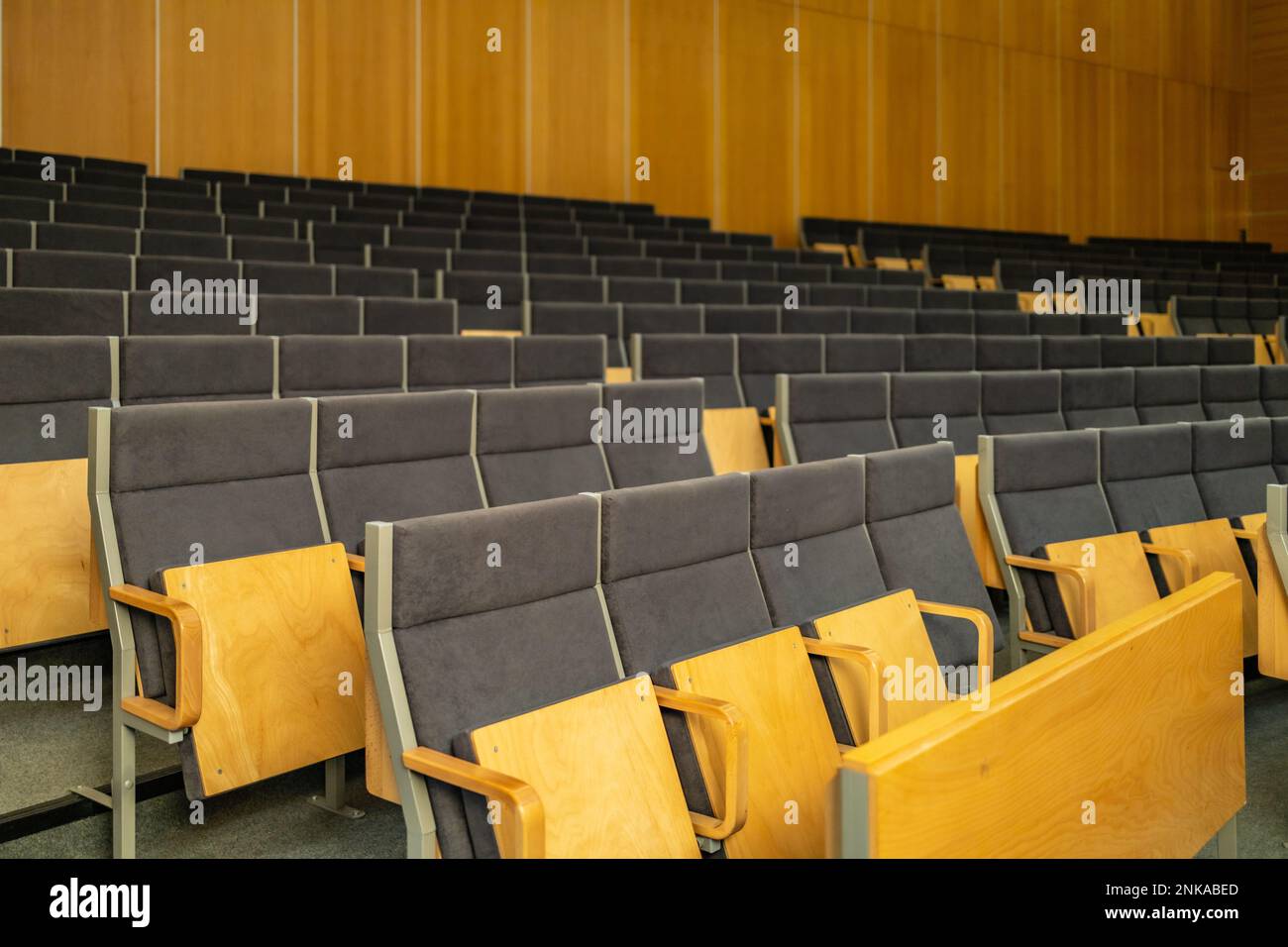 Interior of big conference hall full of gray folding chairs and wooden ...