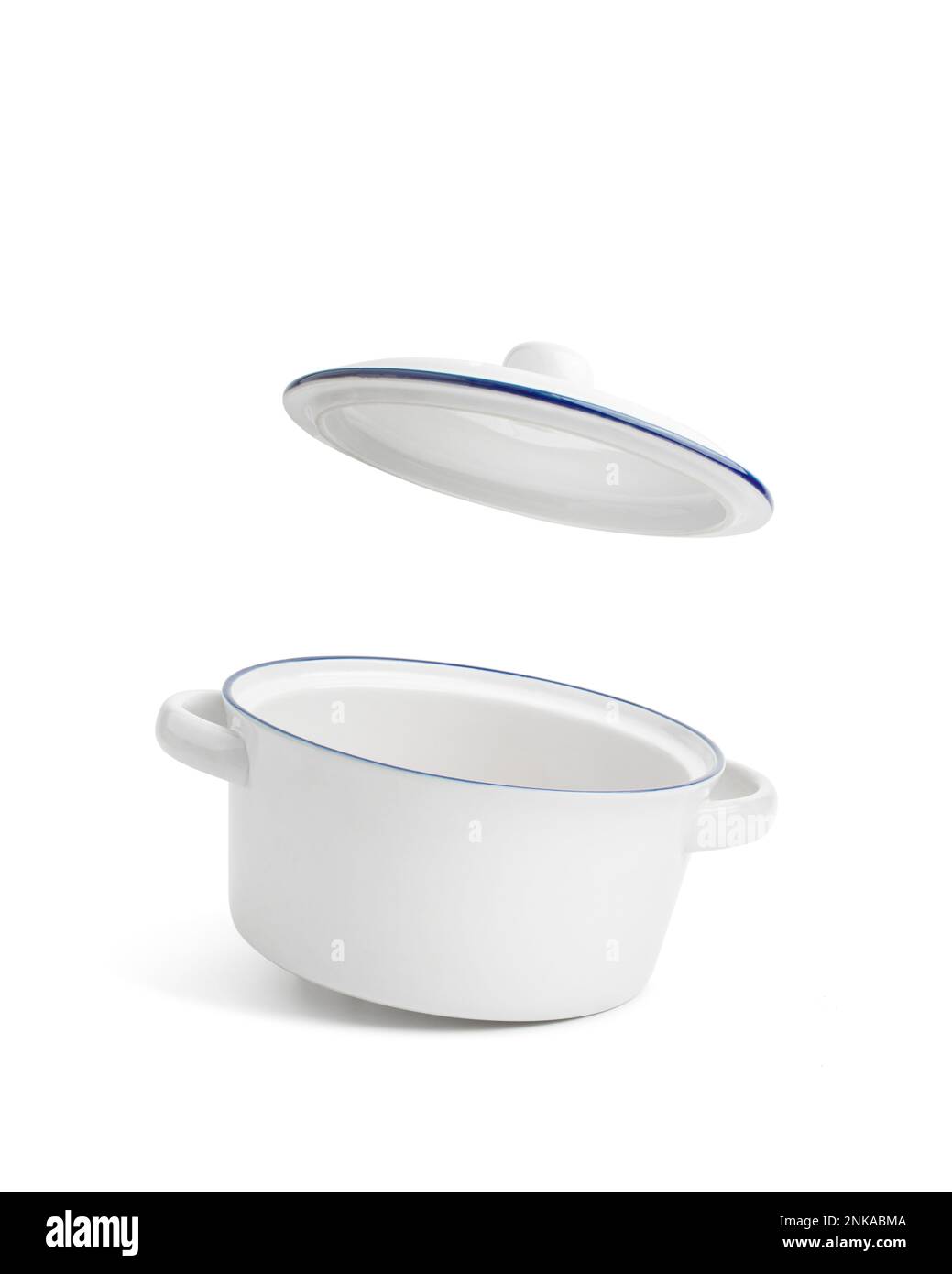 White saucepan with a lid on a white background. Levitation Stock Photo ...