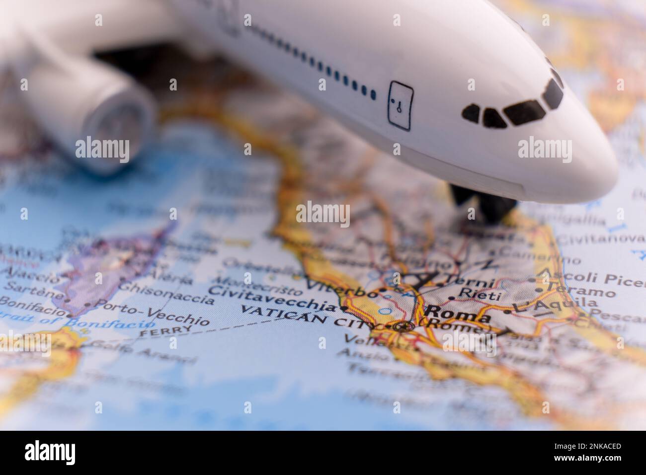 Passenger plane on a map highlighting Rome, Italy through selective ...