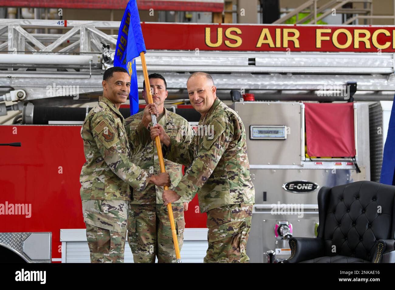 U.S. Air Force Col. Timothy Curry (left), 319th Reconnaissance Wing commander, passes the 319th ...