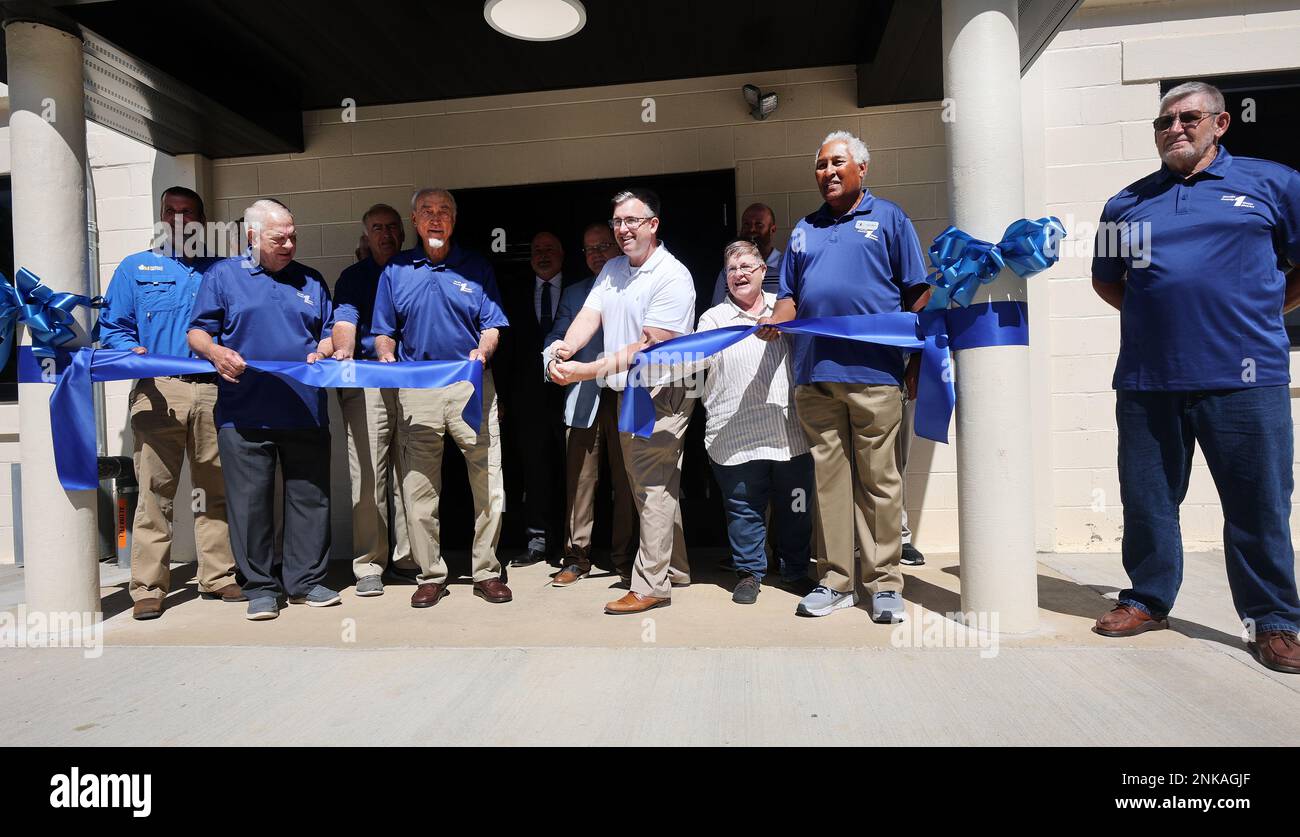 Fort Knox Directorate of Public Works director Jason Root (center) cuts ...