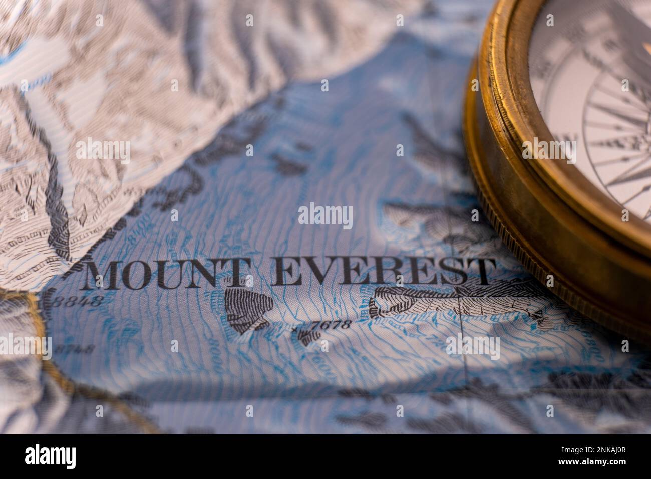 Selective focus close up of vintage compass on map detail of Mt ...