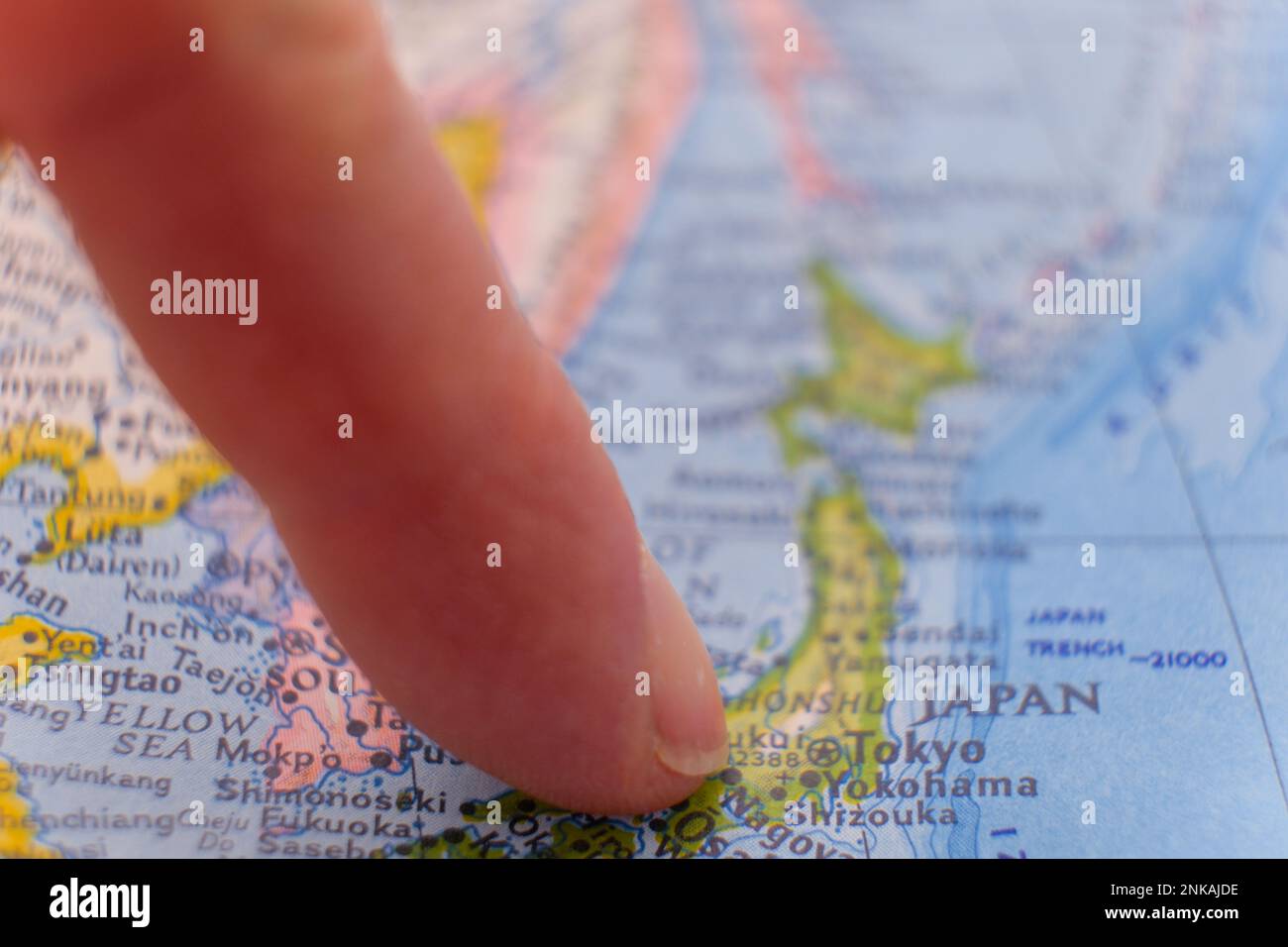 Finger pointing to Tokyo, Japan on colorful map with selective focus ...