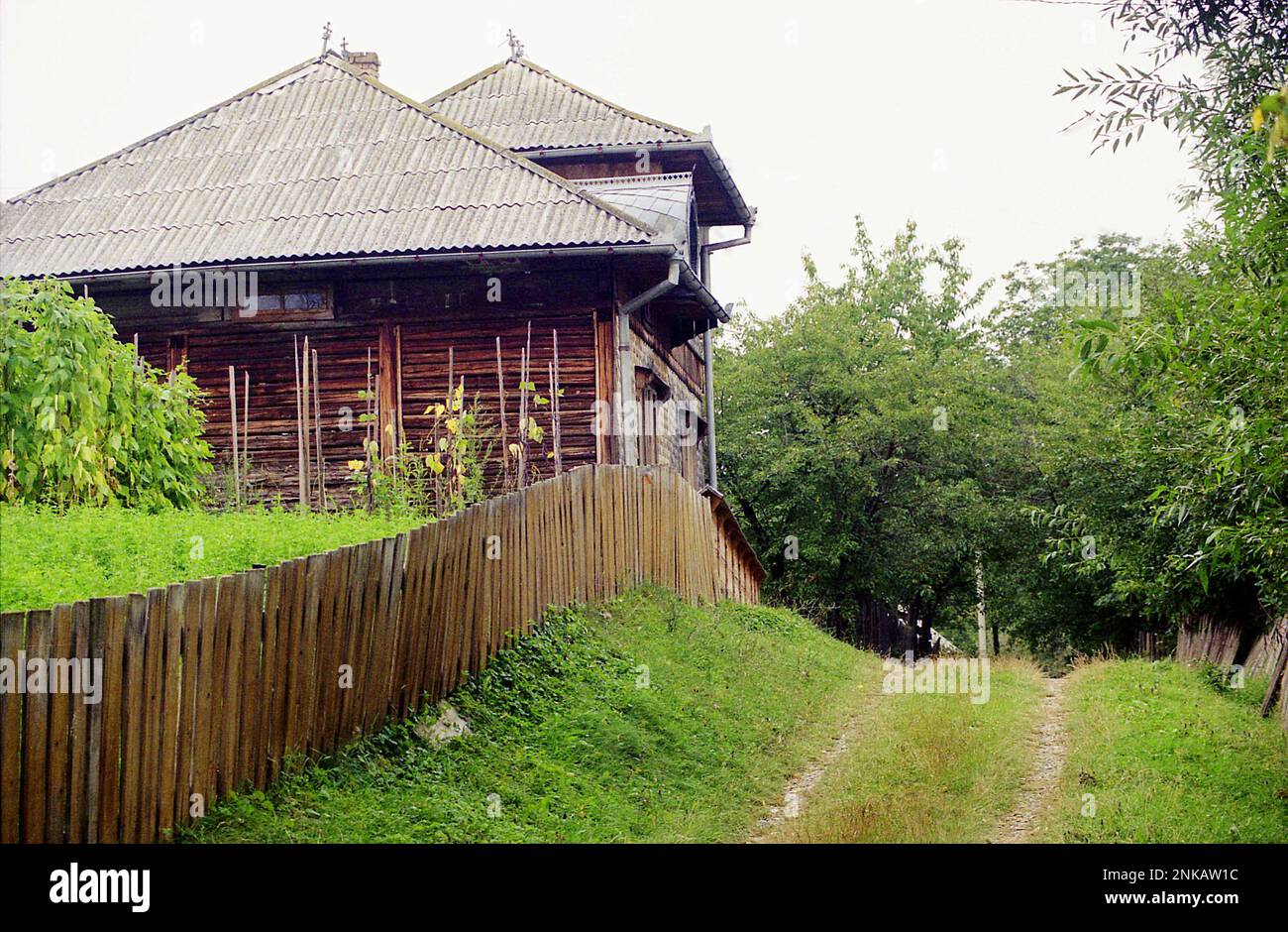 Picturesque country lane passing by a large wooden house in Solonetu ...