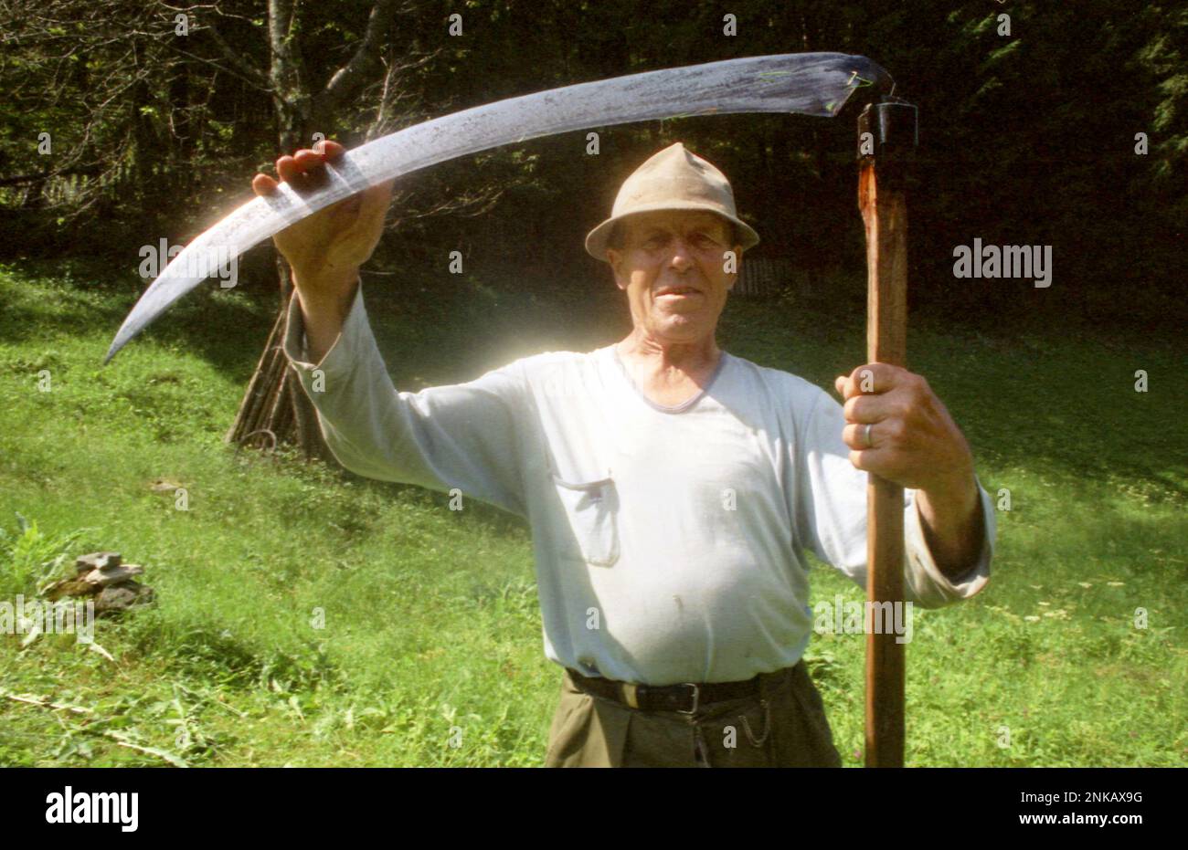 Sibiu County, Romania, approx. 1999. Man checking the blade of his ...