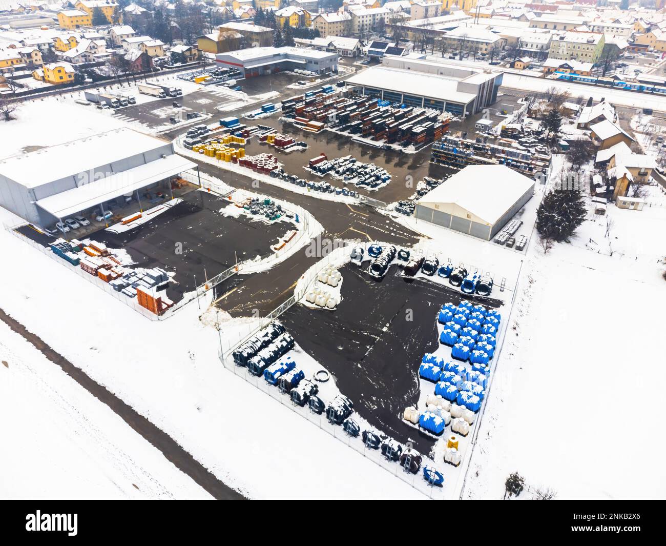 Aerial view of the industrial lot with outdoor warehouses in winter ...