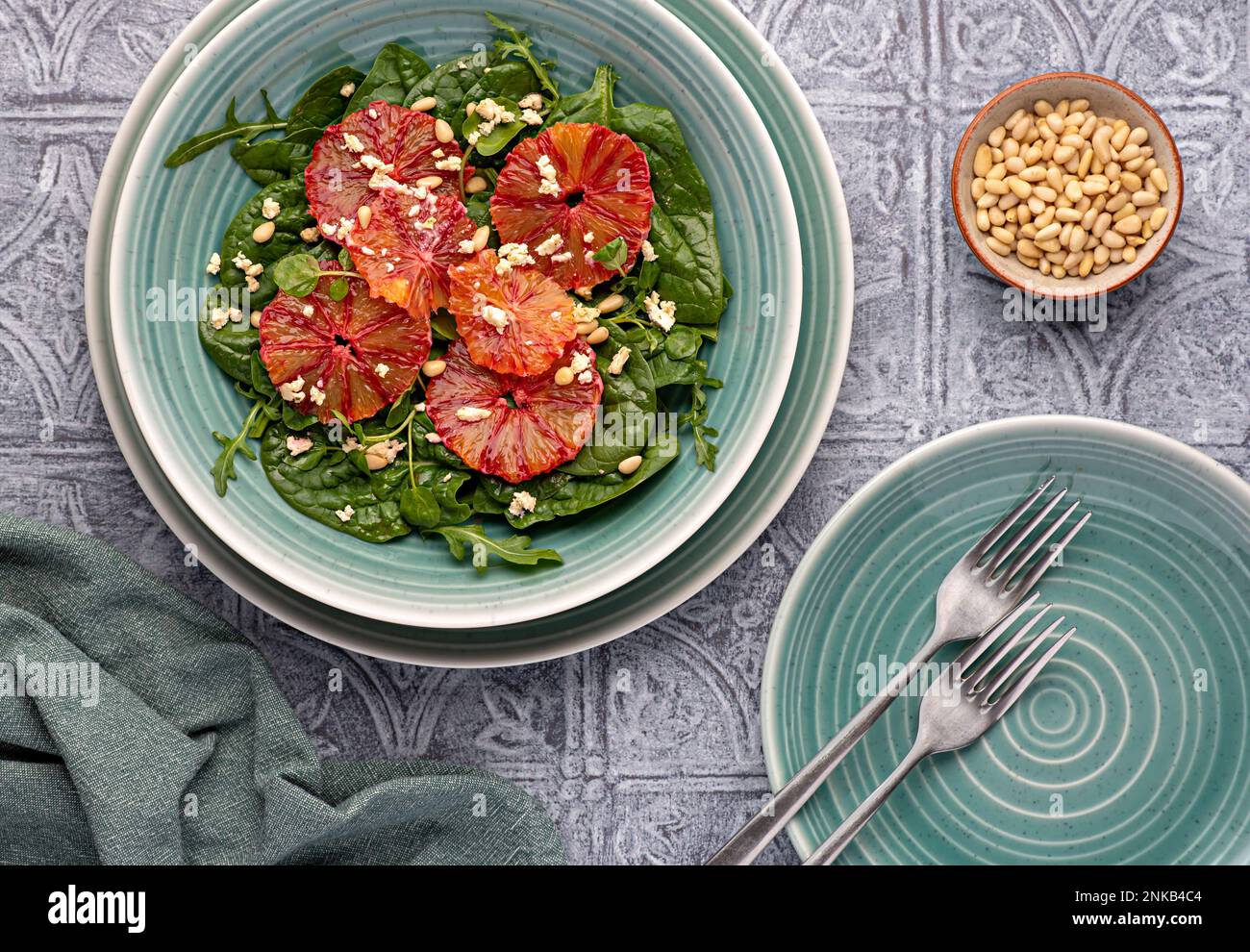 Food photography of salad with red orange, feta, spinach, arugula, pine ...