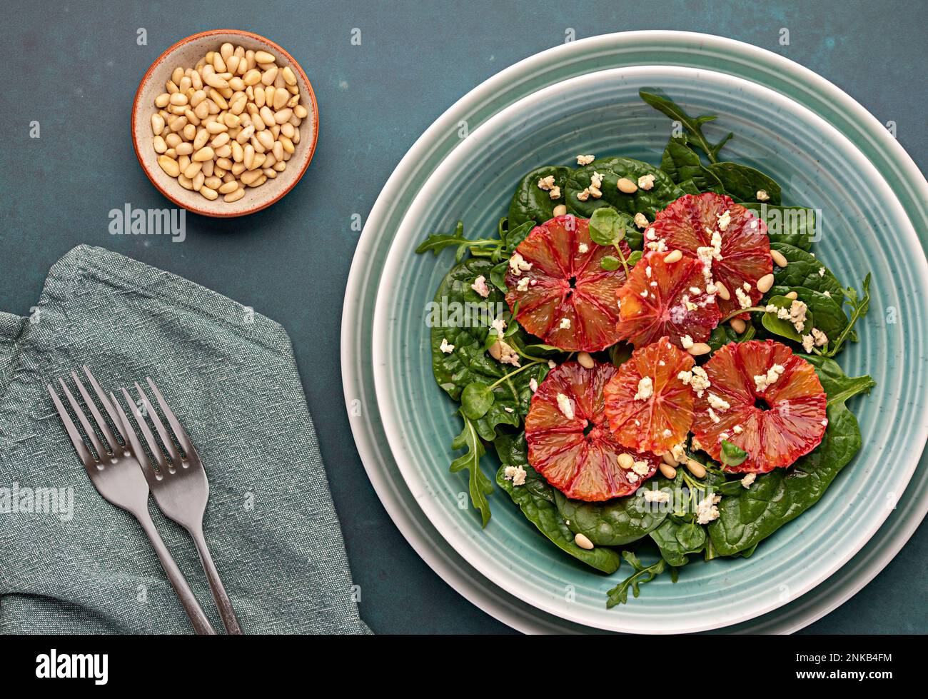 Food photography of salad with red orange, feta, spinach, arugula, pine ...