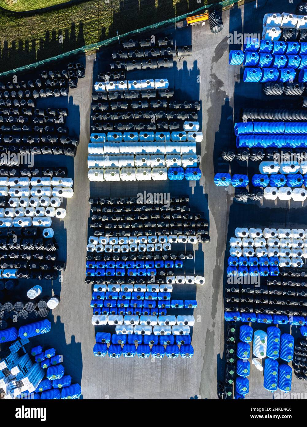 Industrial outdoor plastic pipes and bulk goods stored outside, top ...
