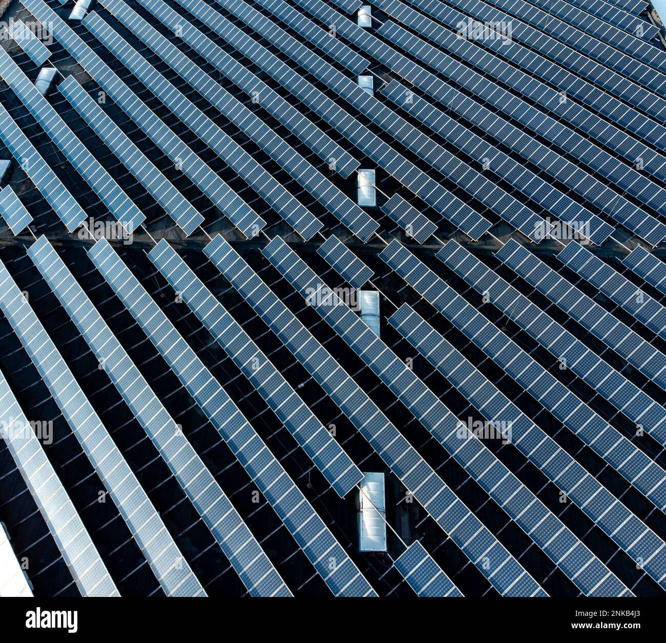 Large solar panel array stacked farm on a distribution warehouse ...