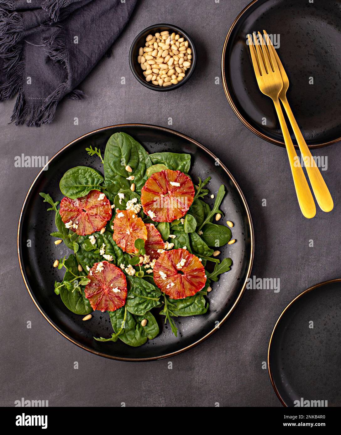 Food photography of salad with red orange, feta, spinach, arugula, pine ...