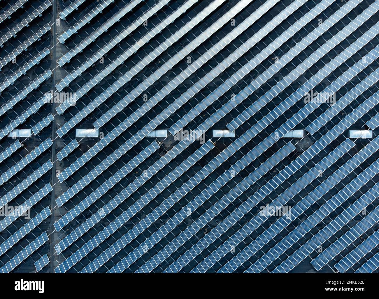 Large solar panel array stacked farm on a distribution warehouse ...