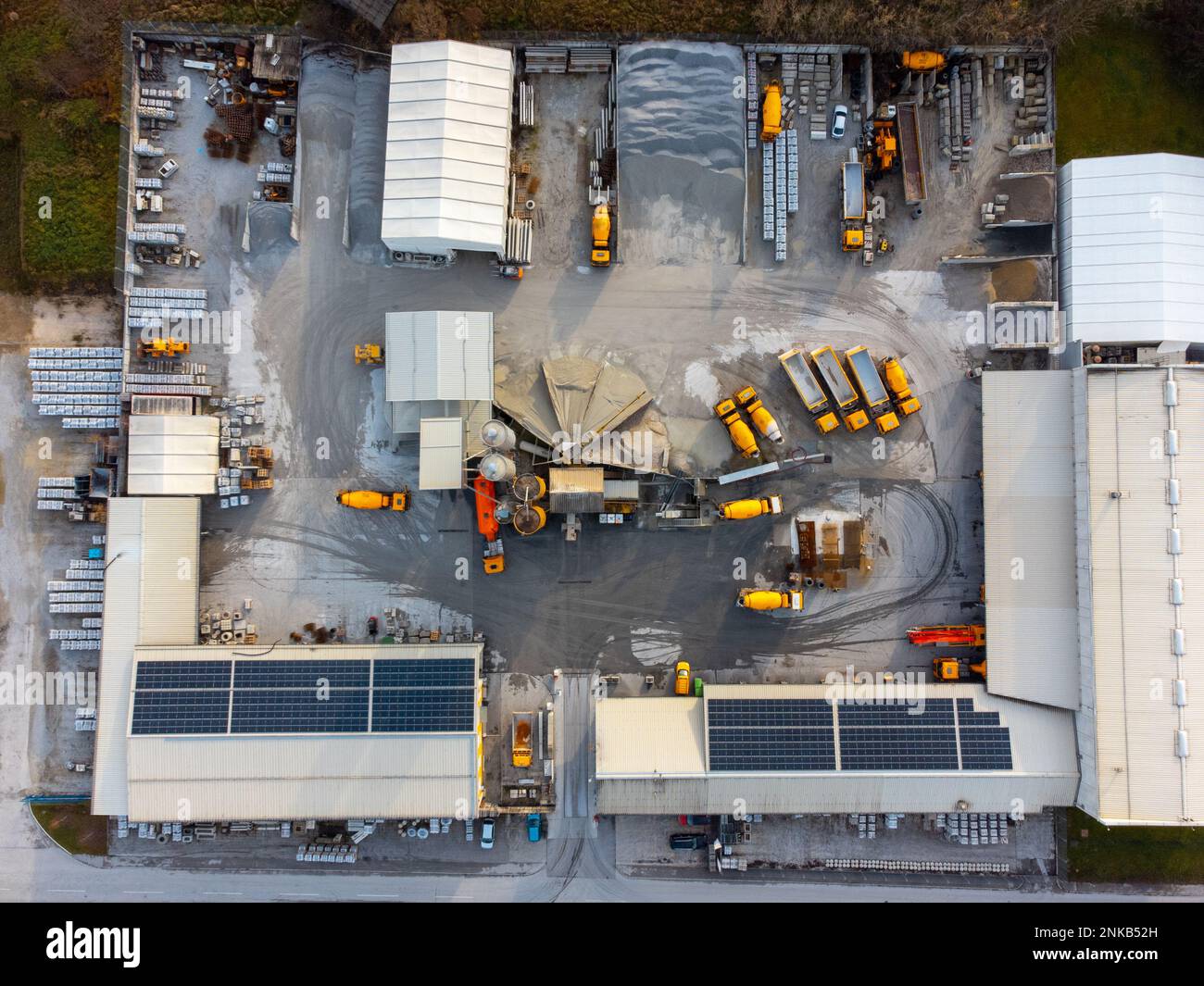 Construction and concrete factory lot, solar panels on the rooftop and ...