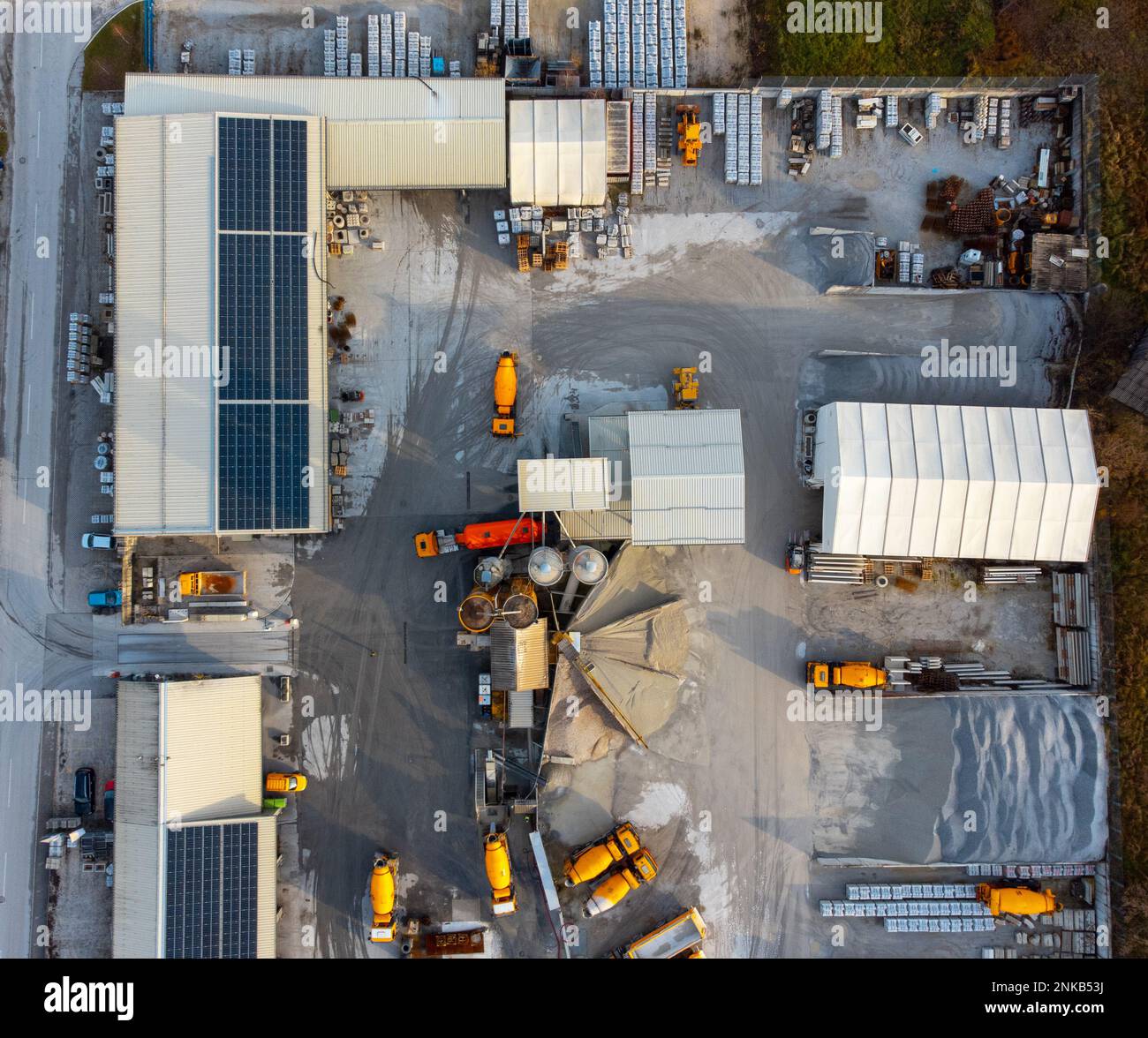 Construction and concrete factory lot, solar panels on the rooftop and ...