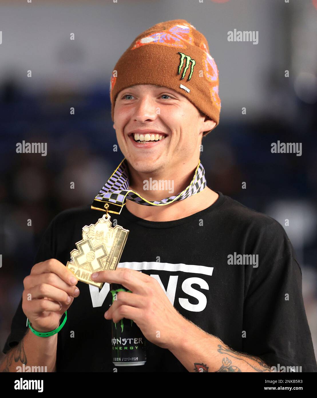 Lewis Mills of Australia shows his gold medal during the awarding ...
