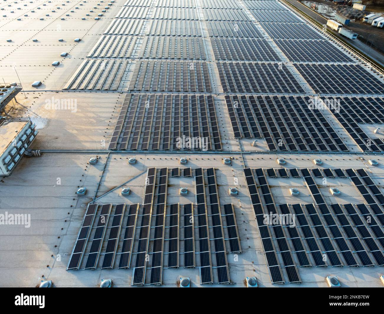 Large solar panel array farm on a commercial warehouse building in ...