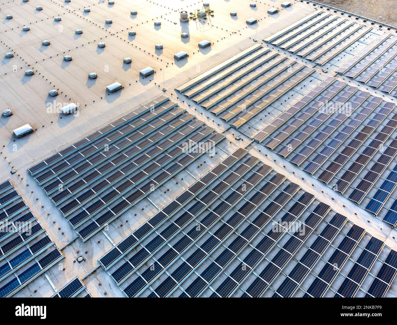Large solar panel array farm on a commercial warehouse building in ...