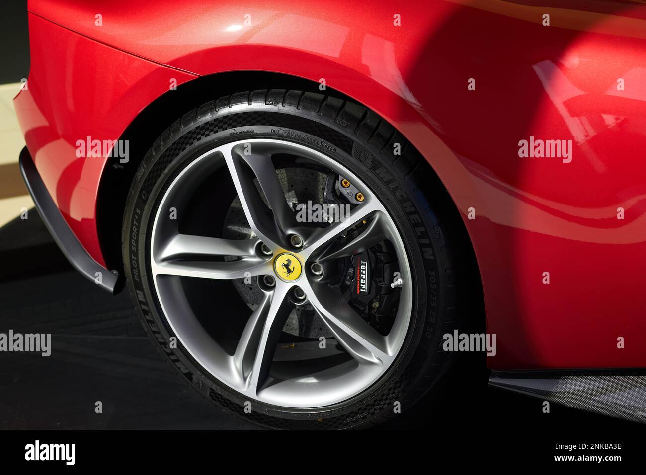 The rear wheel of a red Ferrari 296 GTB. Tire Michelin Pilot Sport 4 S ...