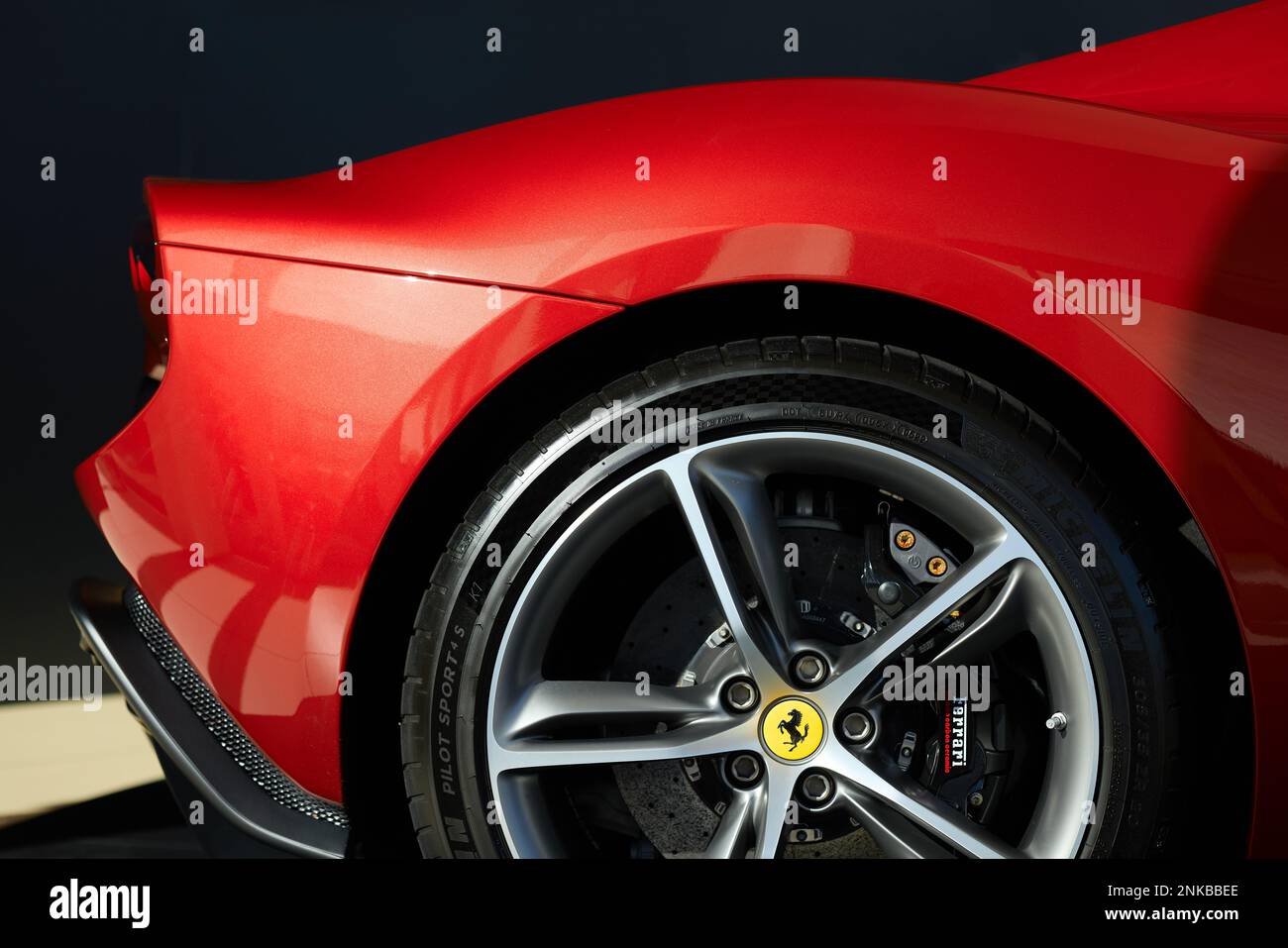 The rear wheel of a red Ferrari 296 GTB. Tire Michelin Pilot Sport 4 S ...