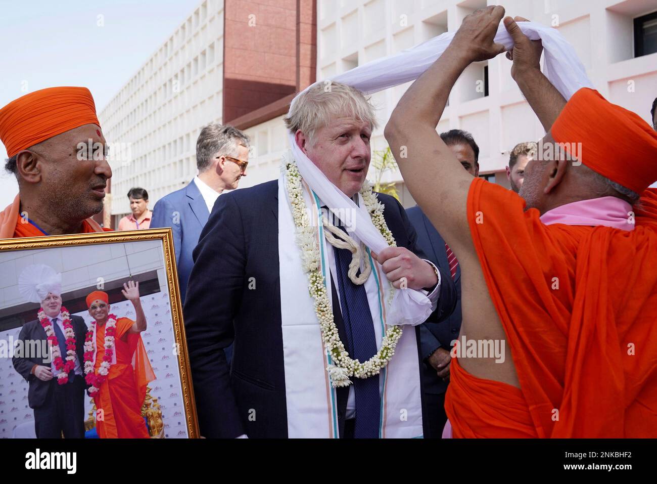 Britain's Prime Minister Boris Johnson, left, has a turban placed on ...