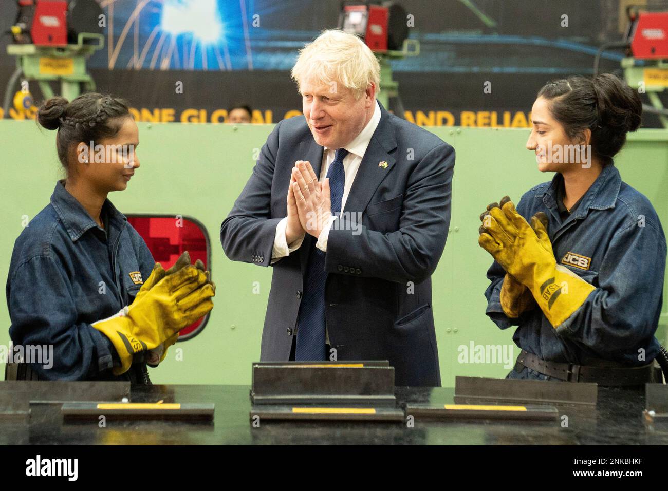 Britain's Prime Minister Boris Johnson speaks to workers at the new JCB ...