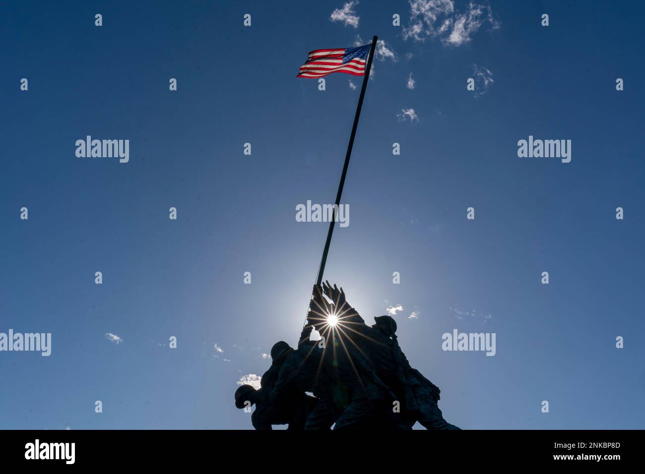 The sun sets behind the U.S. Marine Corps Memorial, Thursday, Feb. 23 ...