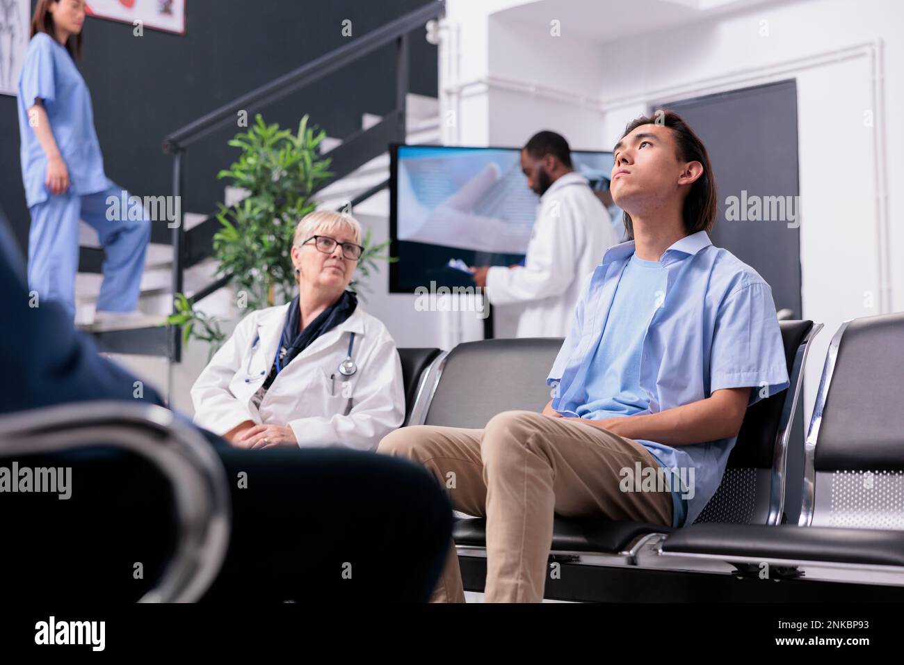 Asian patient being stressed and tired during checkup visit ...