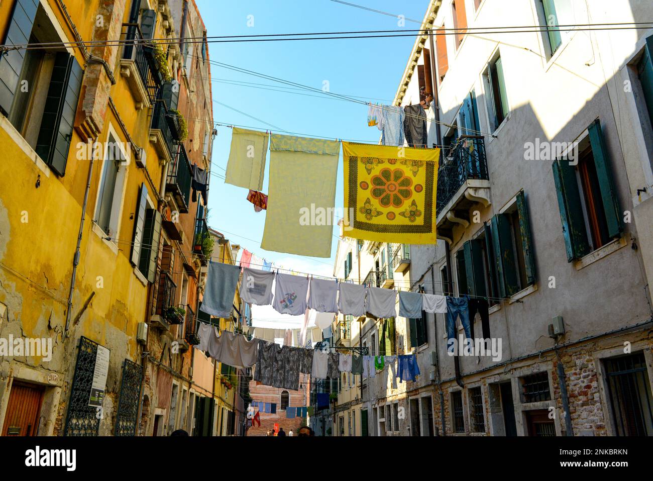 Typical city corner with ancient colorful buildings Drying clothes on a ...