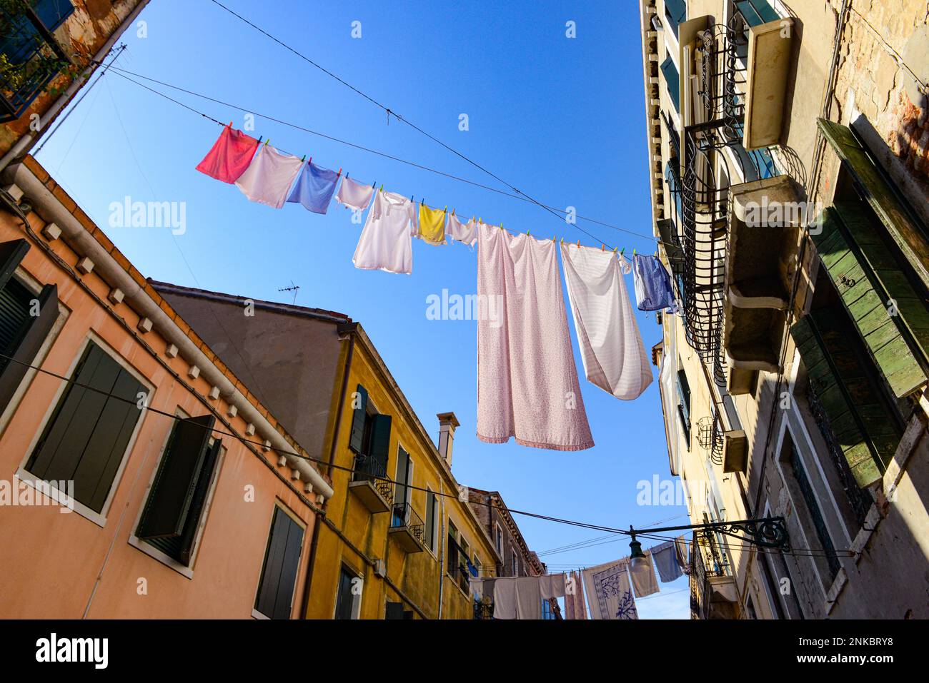 Typical city corner with ancient colorful buildings Drying clothes on a ...