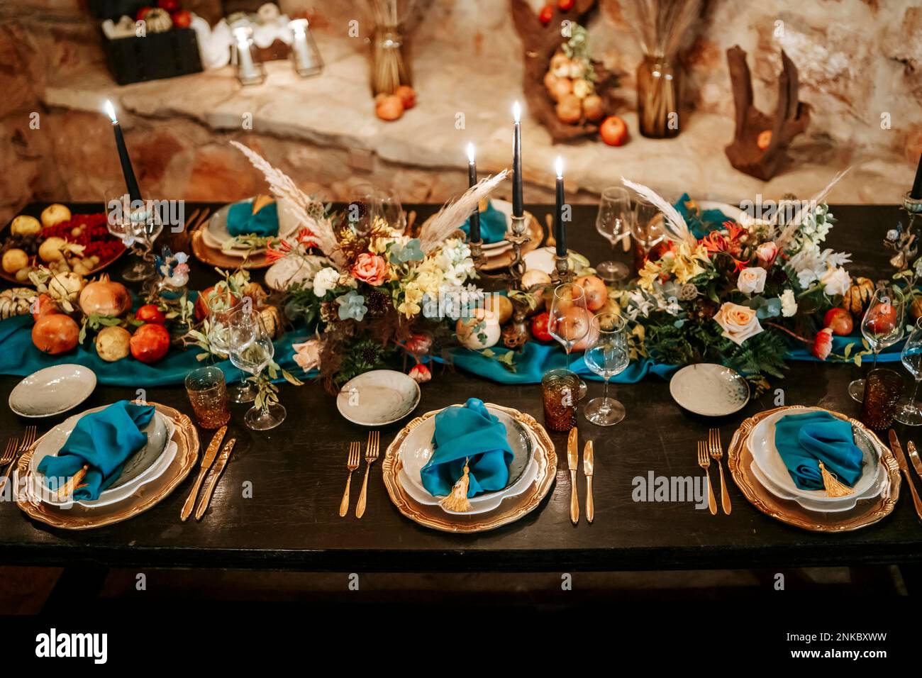 Exquisite, elegant golden and blue table set decoration in moody dark ...