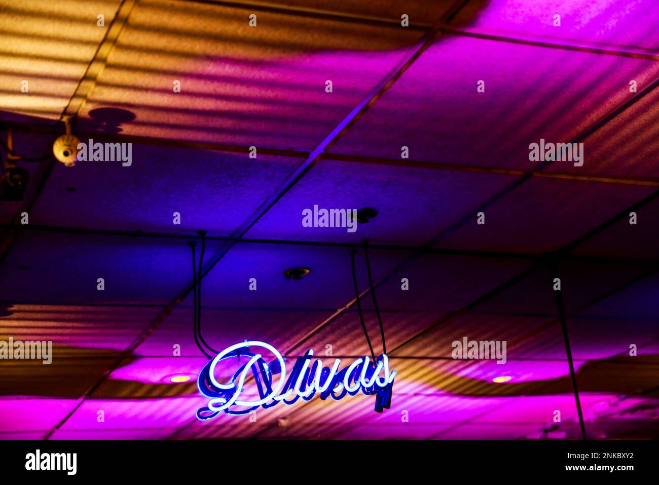 A flourescent sign marks the entrance to the first floor at Divas bar ...