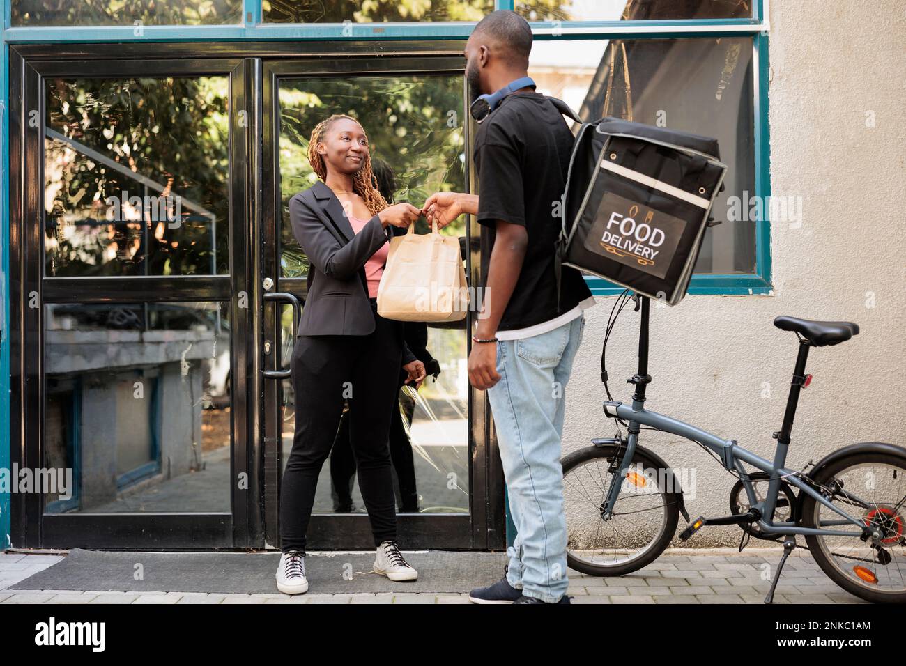 Office food delivery, courier giving customer order paper bag. Man ...