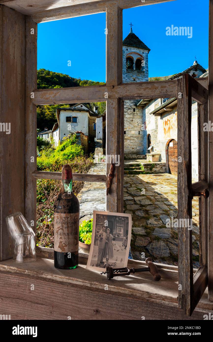 Farmhouse parlour with wine bottle, corkscrew, glasses and photograph ...