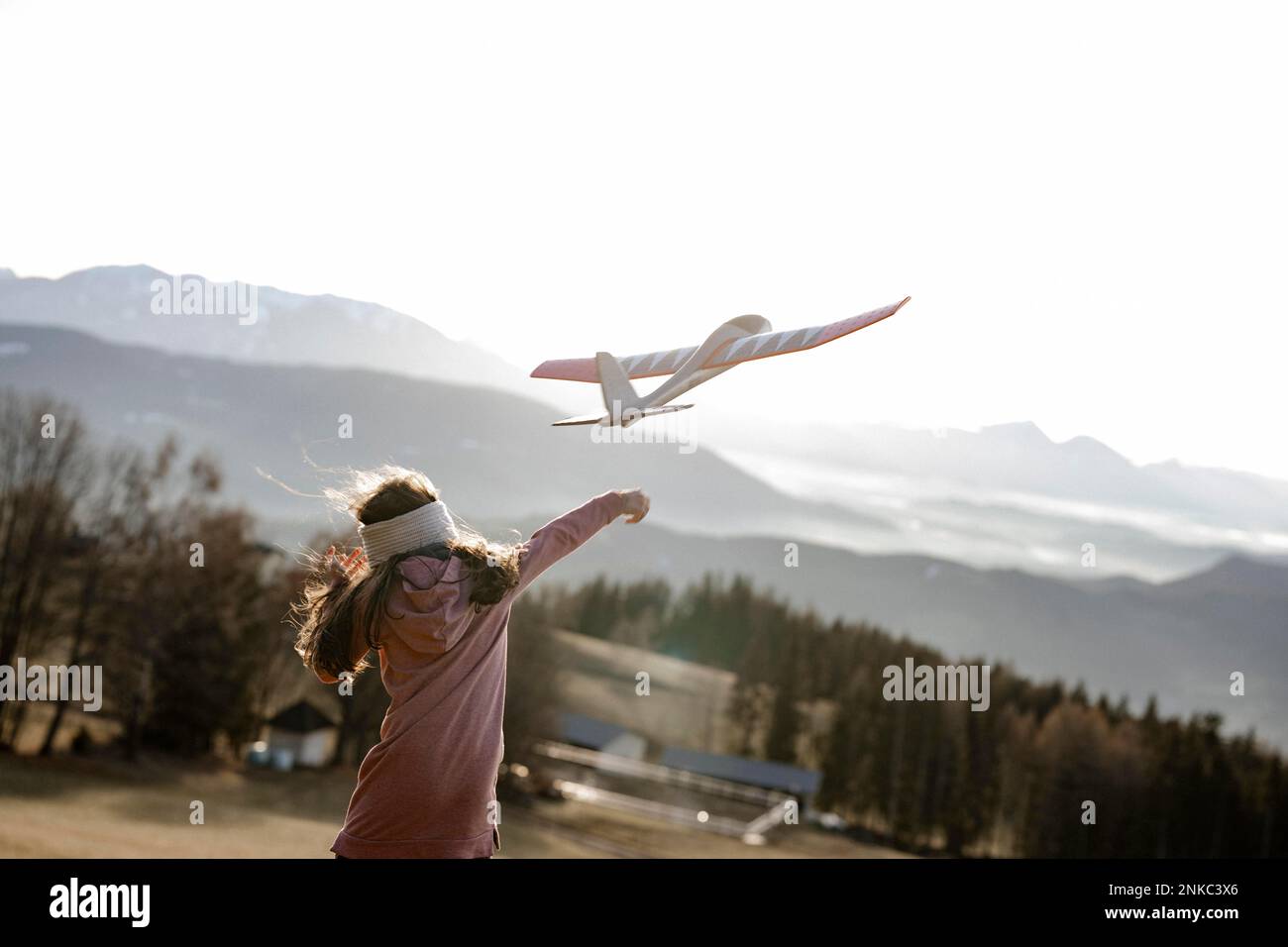 Girl playing with model glider Stock Photo - Alamy