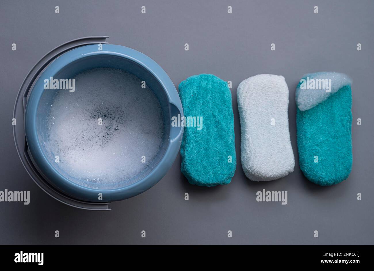 Cleaning sponges with cleaning bucket and foam Stock Photo - Alamy
