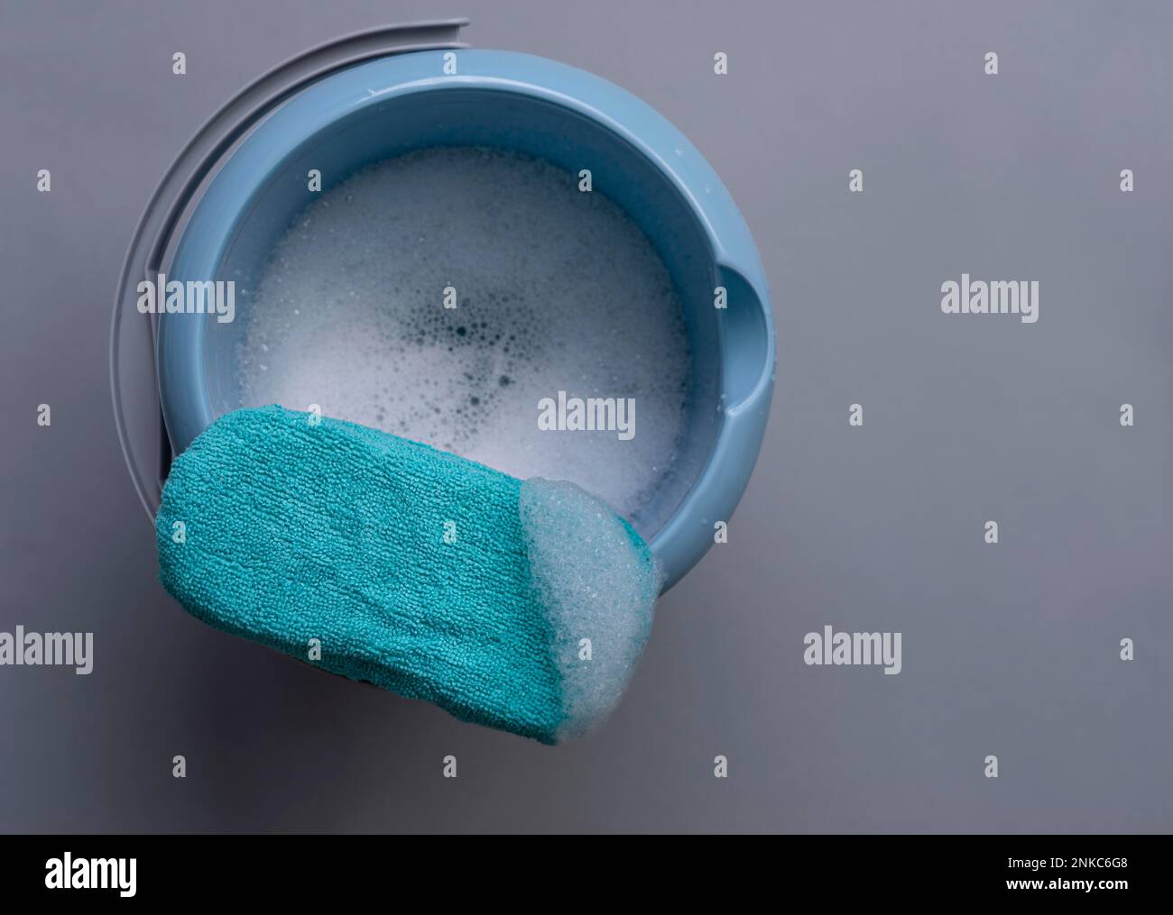 Cleaning sponge with cleaning bucket and foam Stock Photo - Alamy