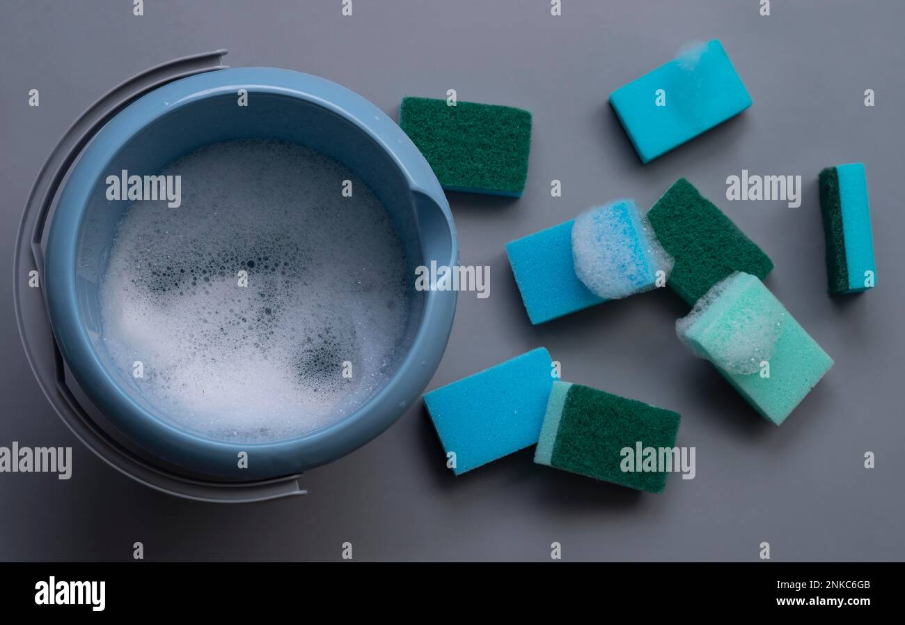 Many cleaning sponges with cleaning bucket and foam Stock Photo - Alamy