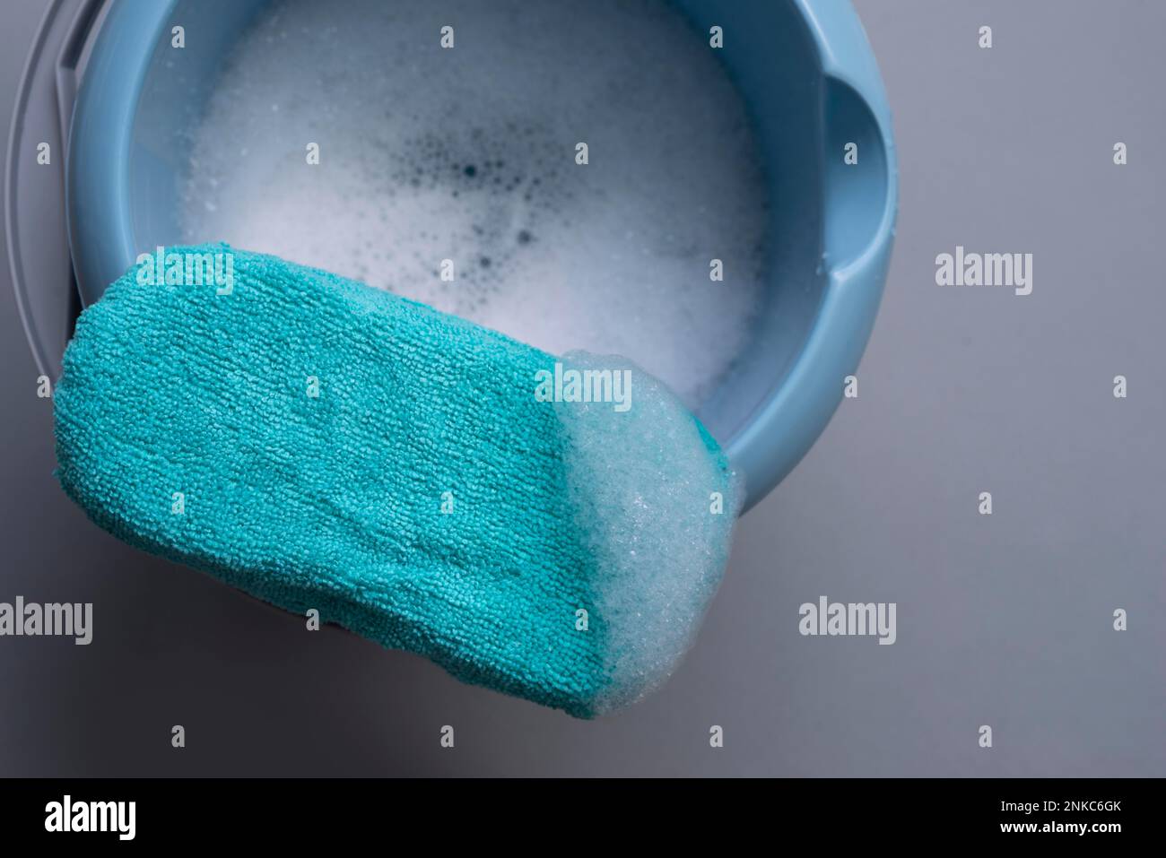 Cleaning sponge with cleaning bucket and foam Stock Photo - Alamy
