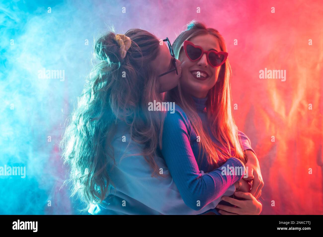 Two young blonde caucasian women dancing in disco, kissing dancing at ...