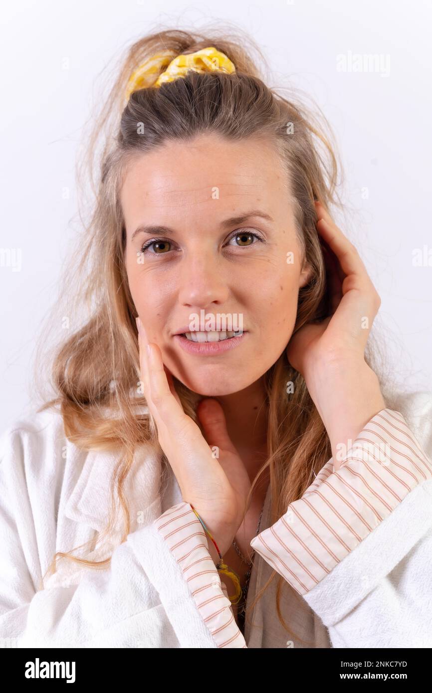 Blond young woman in a portrait isolated on a white background, model ...